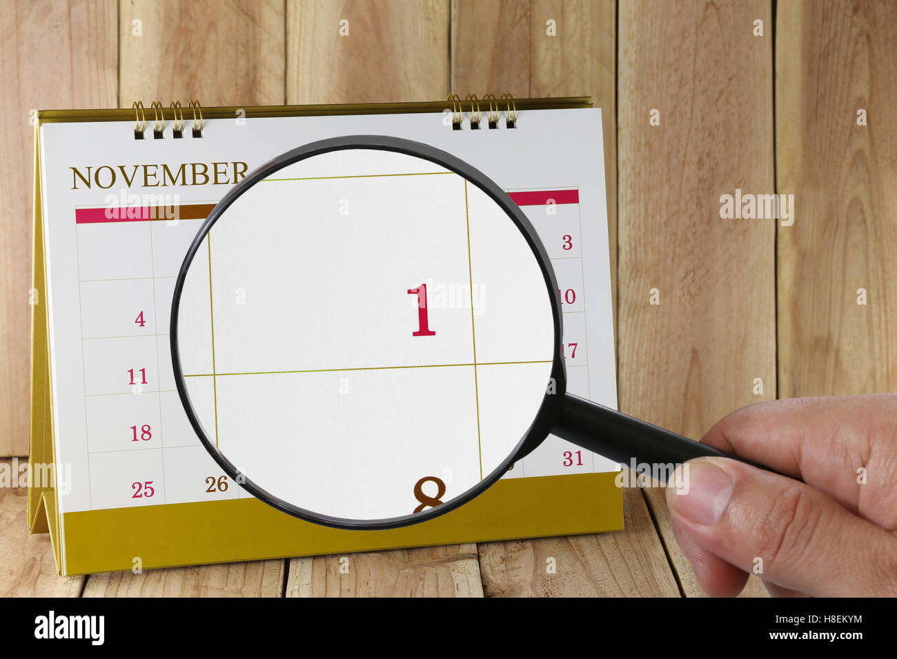 Magnifying glass in hand on calendar you can look first day of month ...