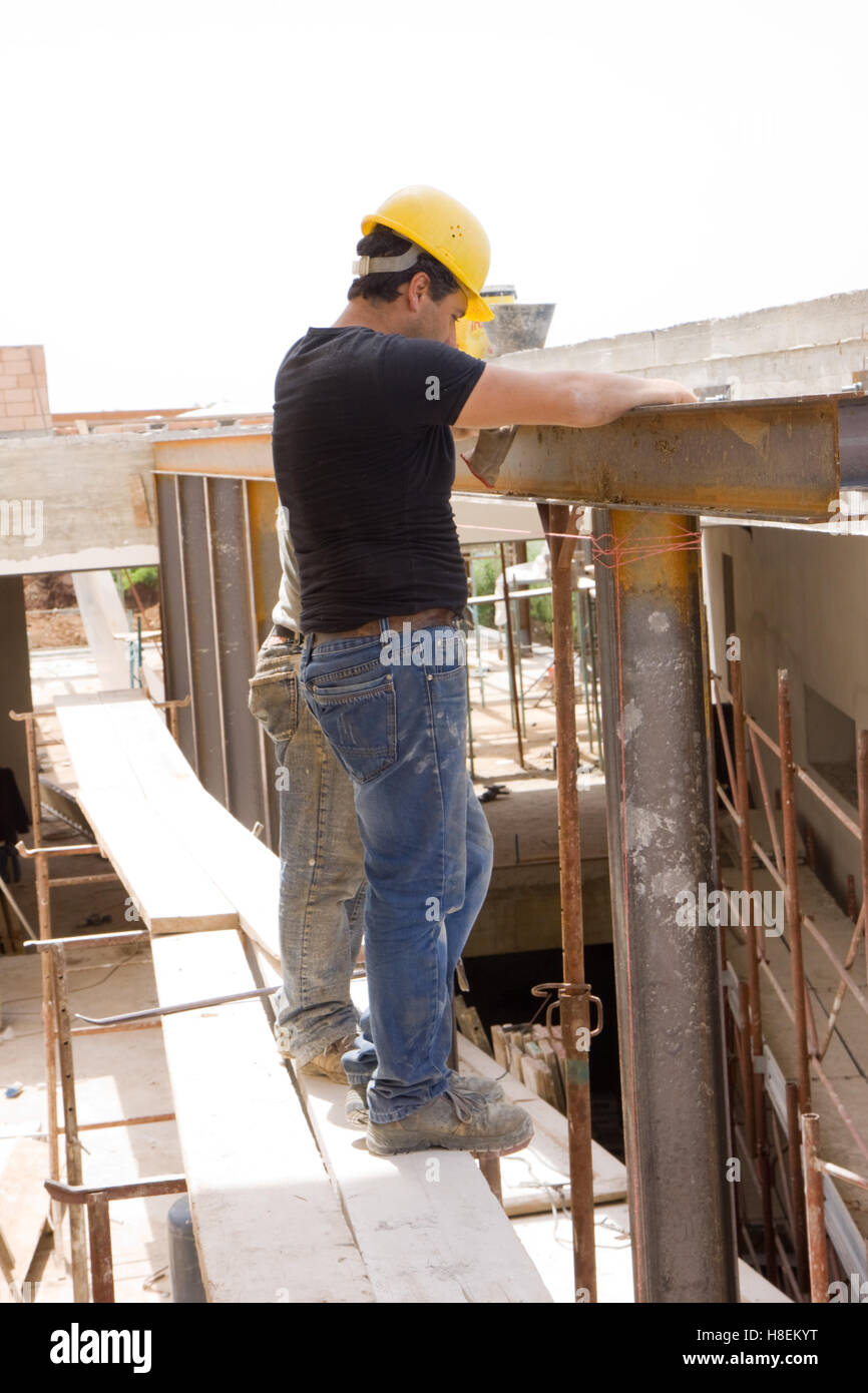 builders at work in a building site Stock Photo - Alamy