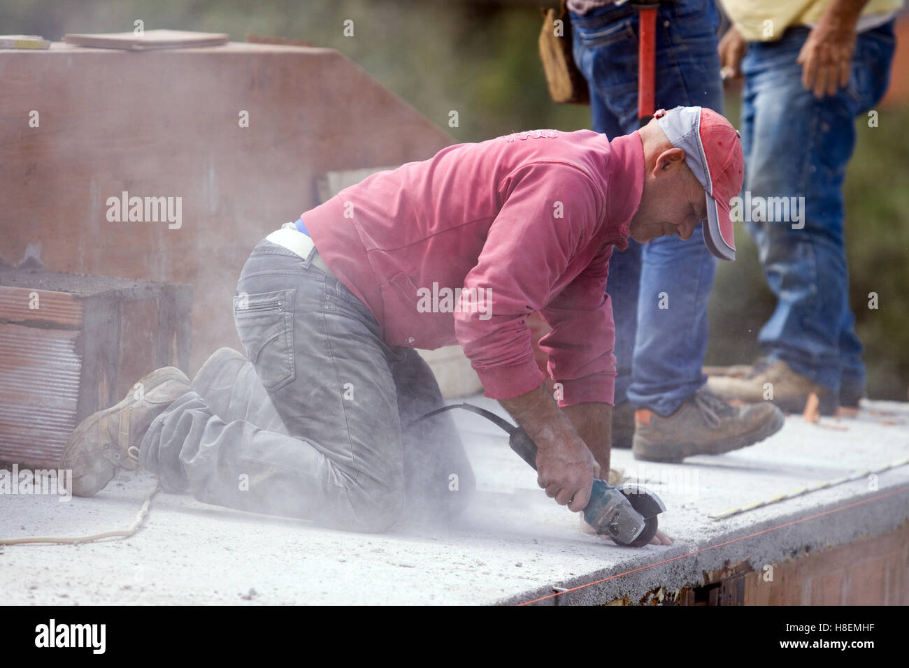 bricklayer working in a building site Stock Photo - Alamy
