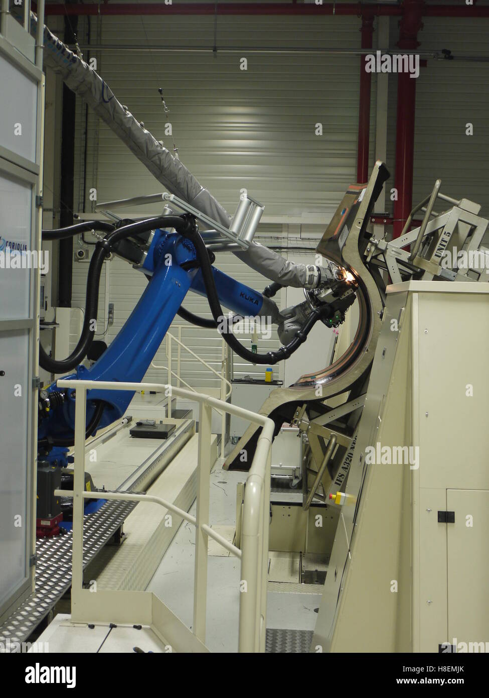 A robot manufactures a carbon part of plane in Safran nacelle plant of ...