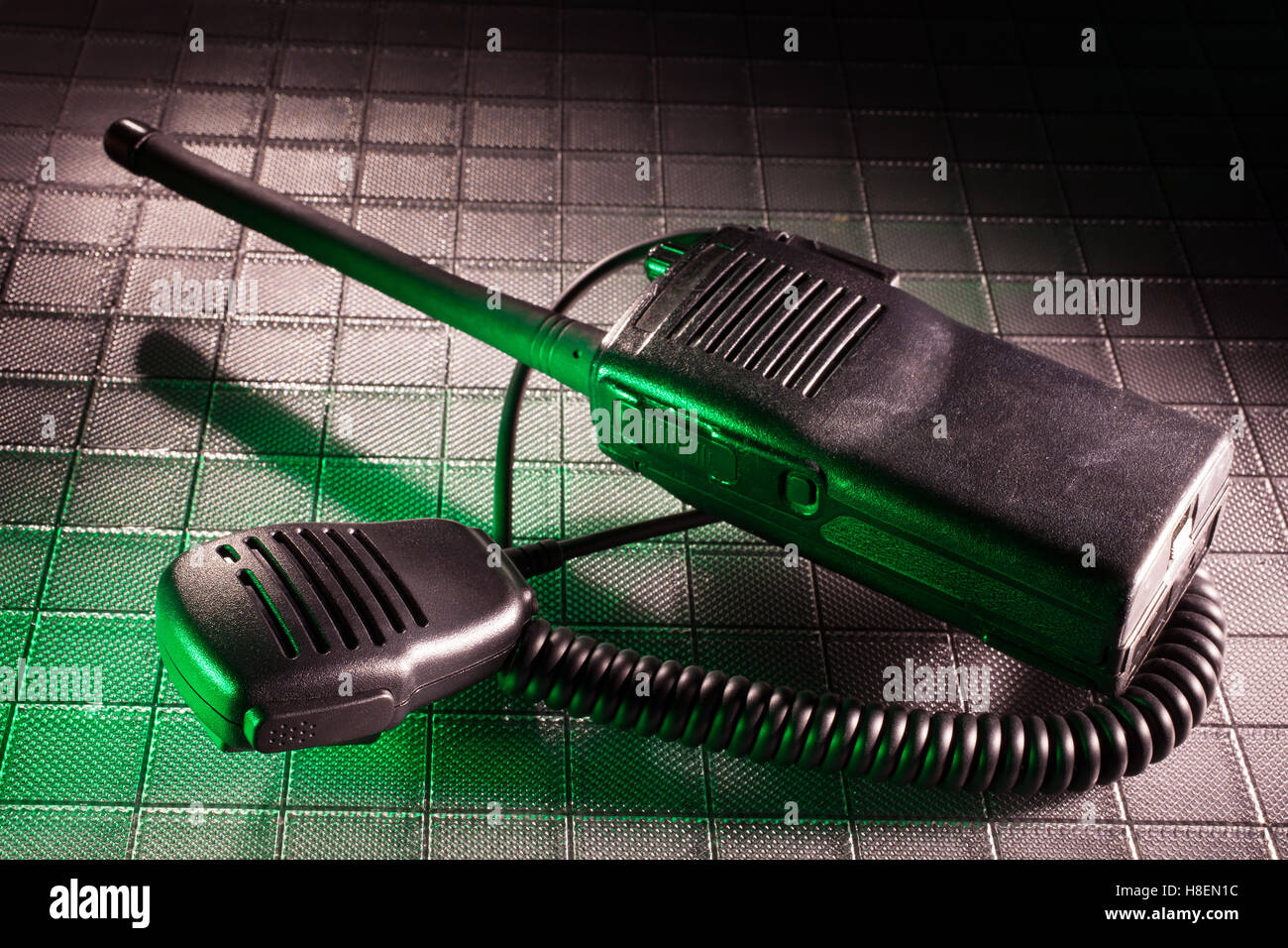 Green light spilling onto a two way radio and its microphone Stock ...