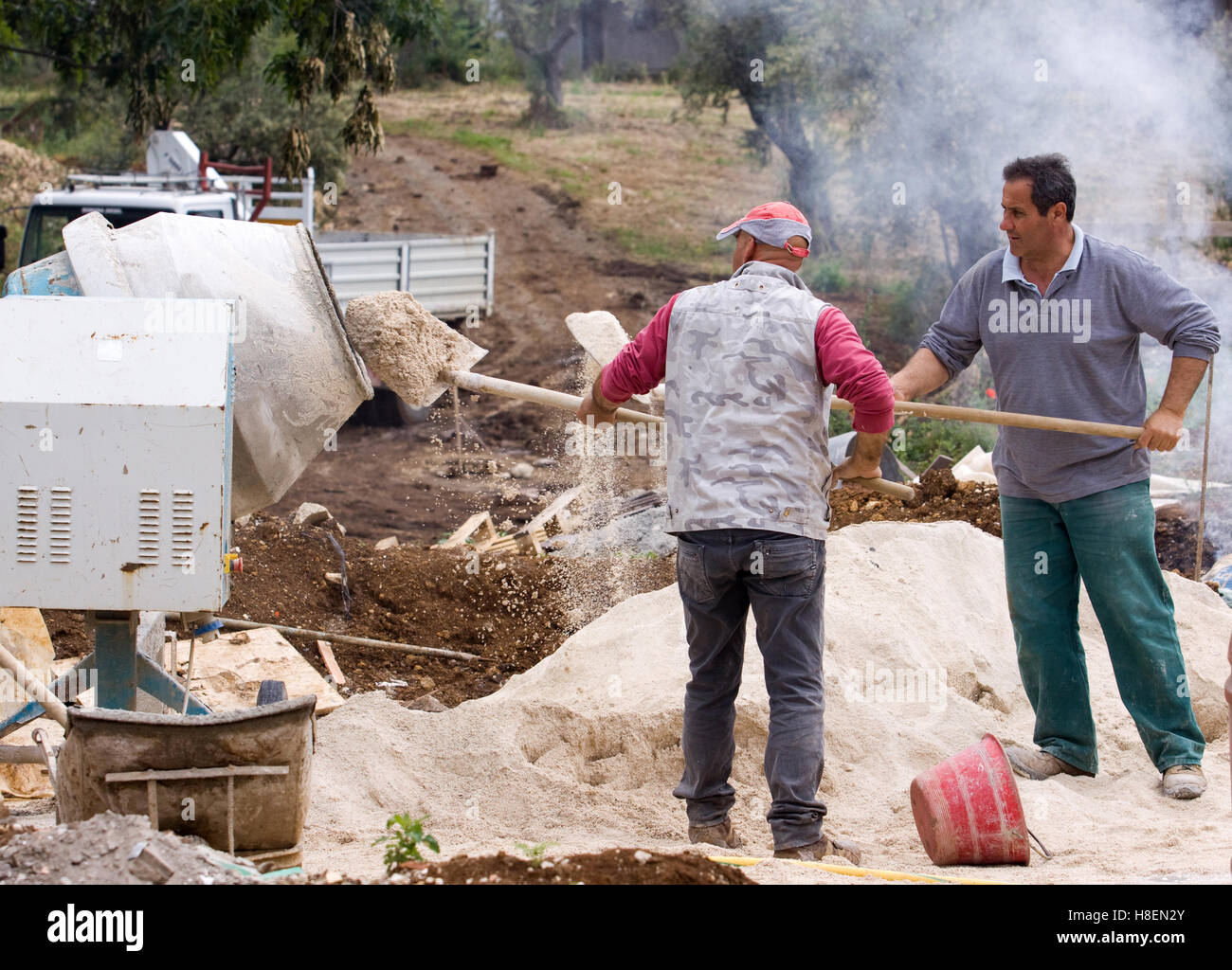 bricklayers working in a building site Stock Photo - Alamy