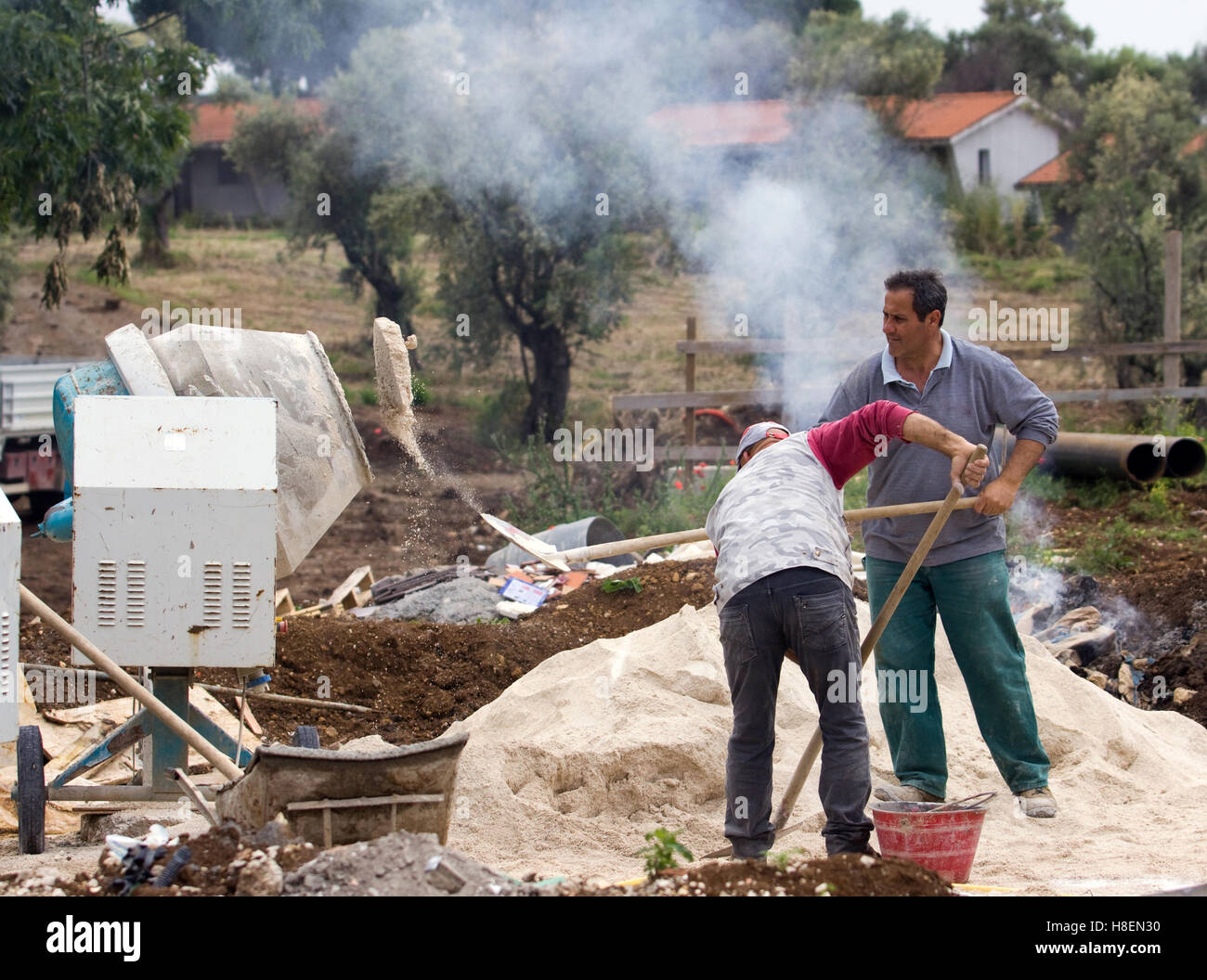 bricklayers working in a building site Stock Photo - Alamy