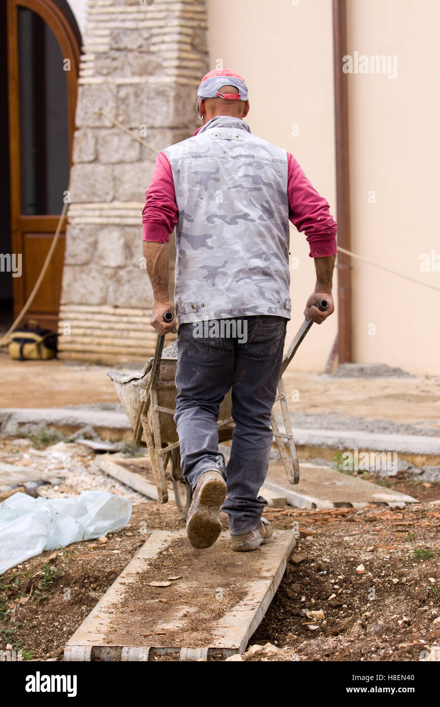 bricklayer working in a building site Stock Photo - Alamy