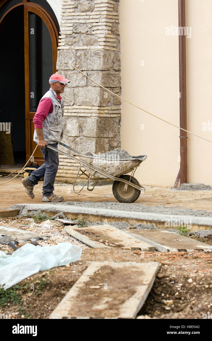 bricklayer working in a building site Stock Photo - Alamy