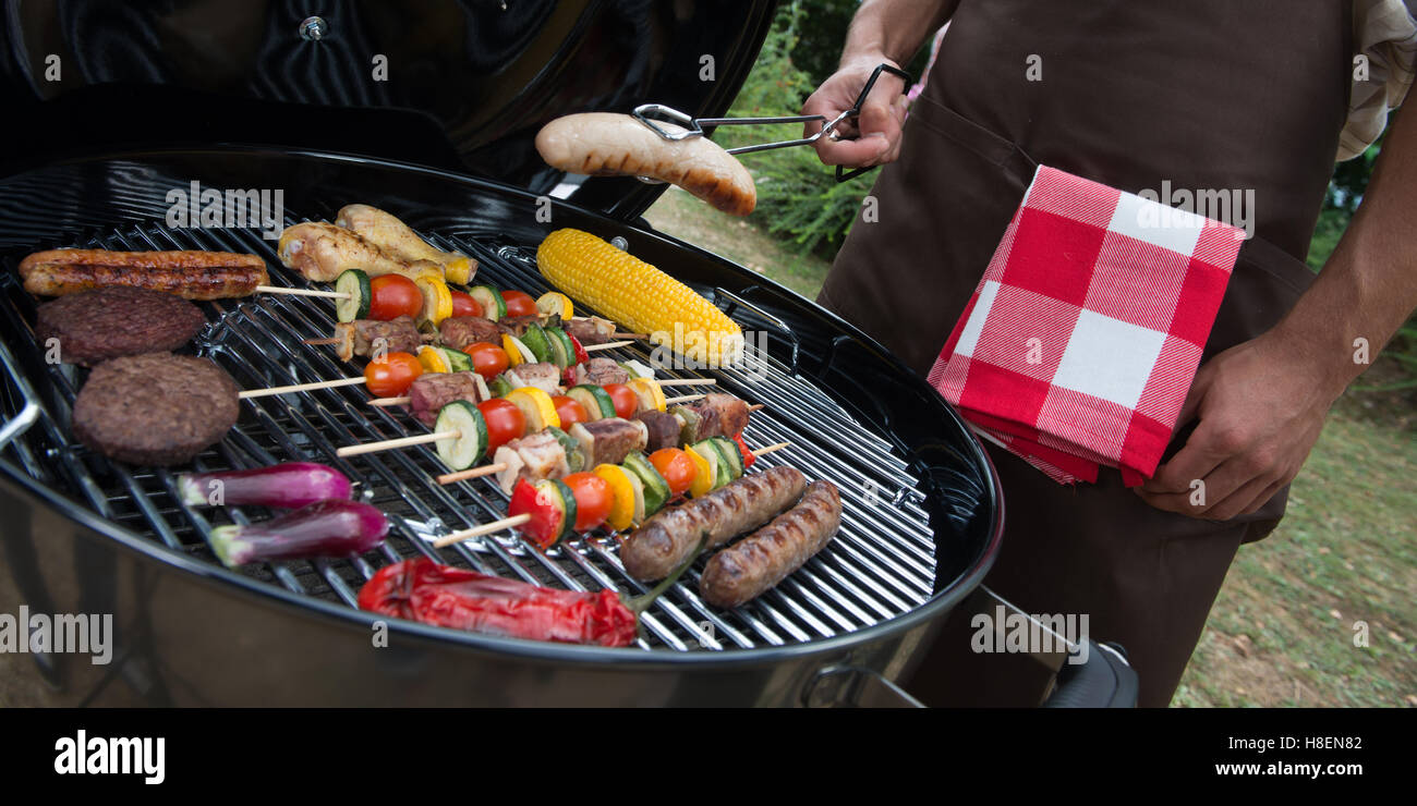 Family having a barbecue party in their garden in summer Stock Photo ...