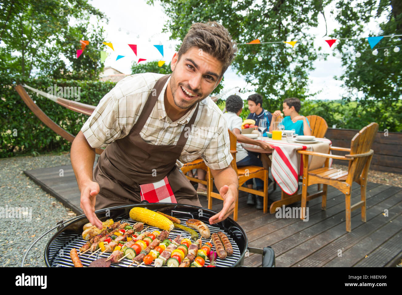 Teenagers during a barbecue at family garden BBQ, outdoor Stock Photo ...