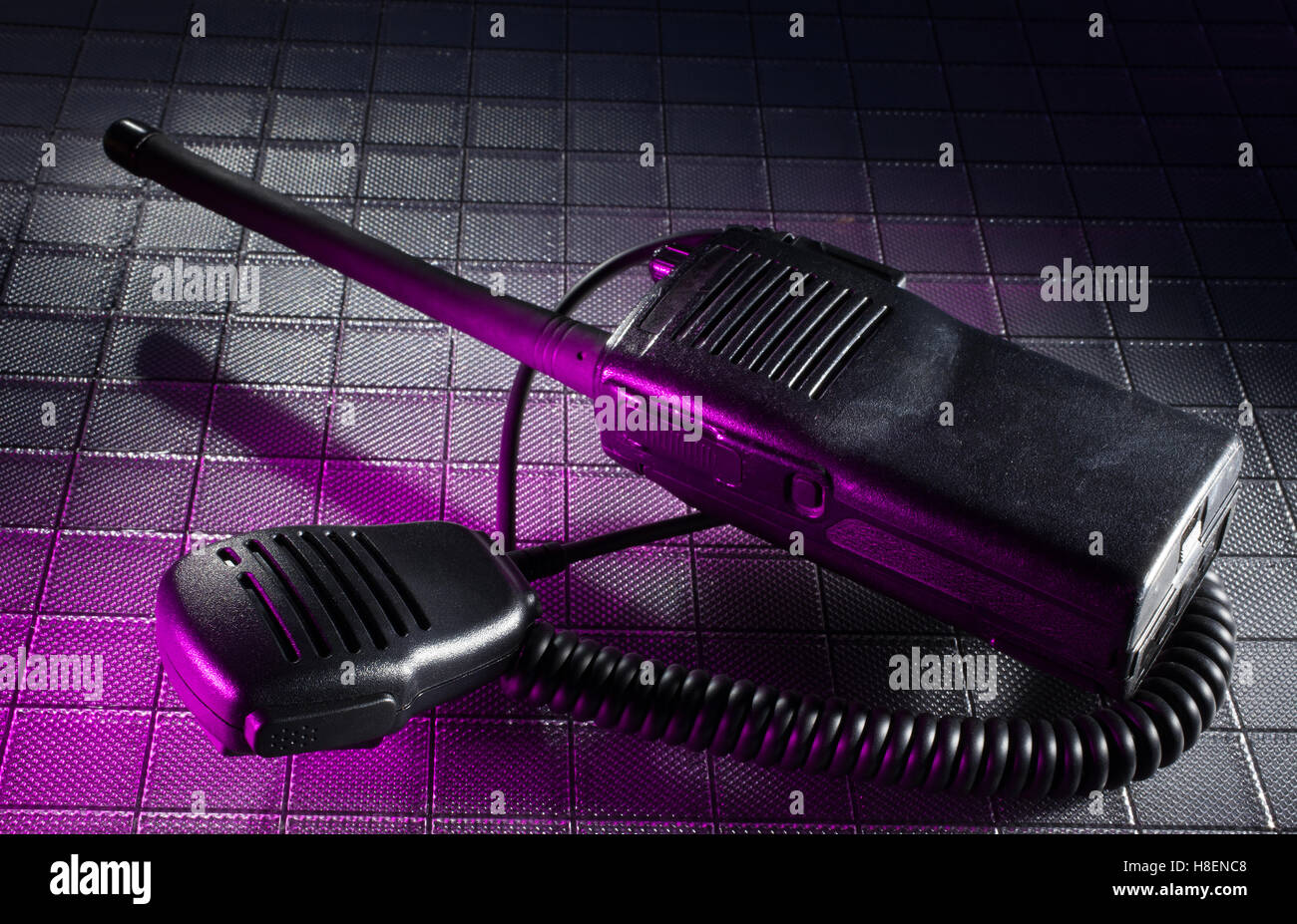 Radio and its microphone on a textured background with purple light ...