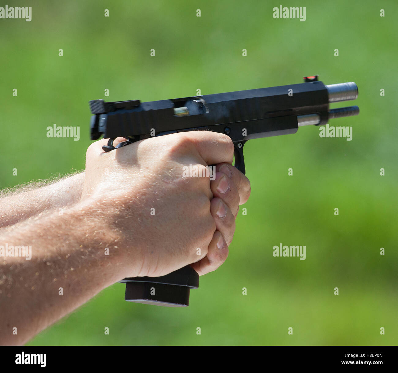 Slide of a semi automatic handgun moving back after a shot Stock Photo ...