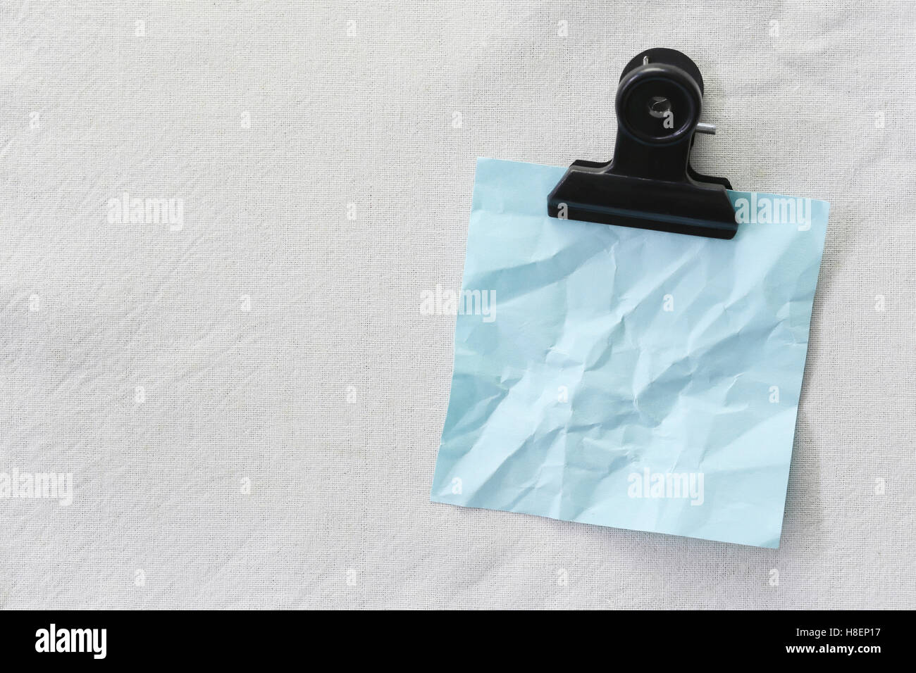 Blue of wrinkled note paper placed on White fabric background,Design ...