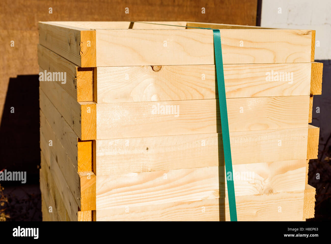 Stack of wooden frames secured by plastic strap and ready for transport ...