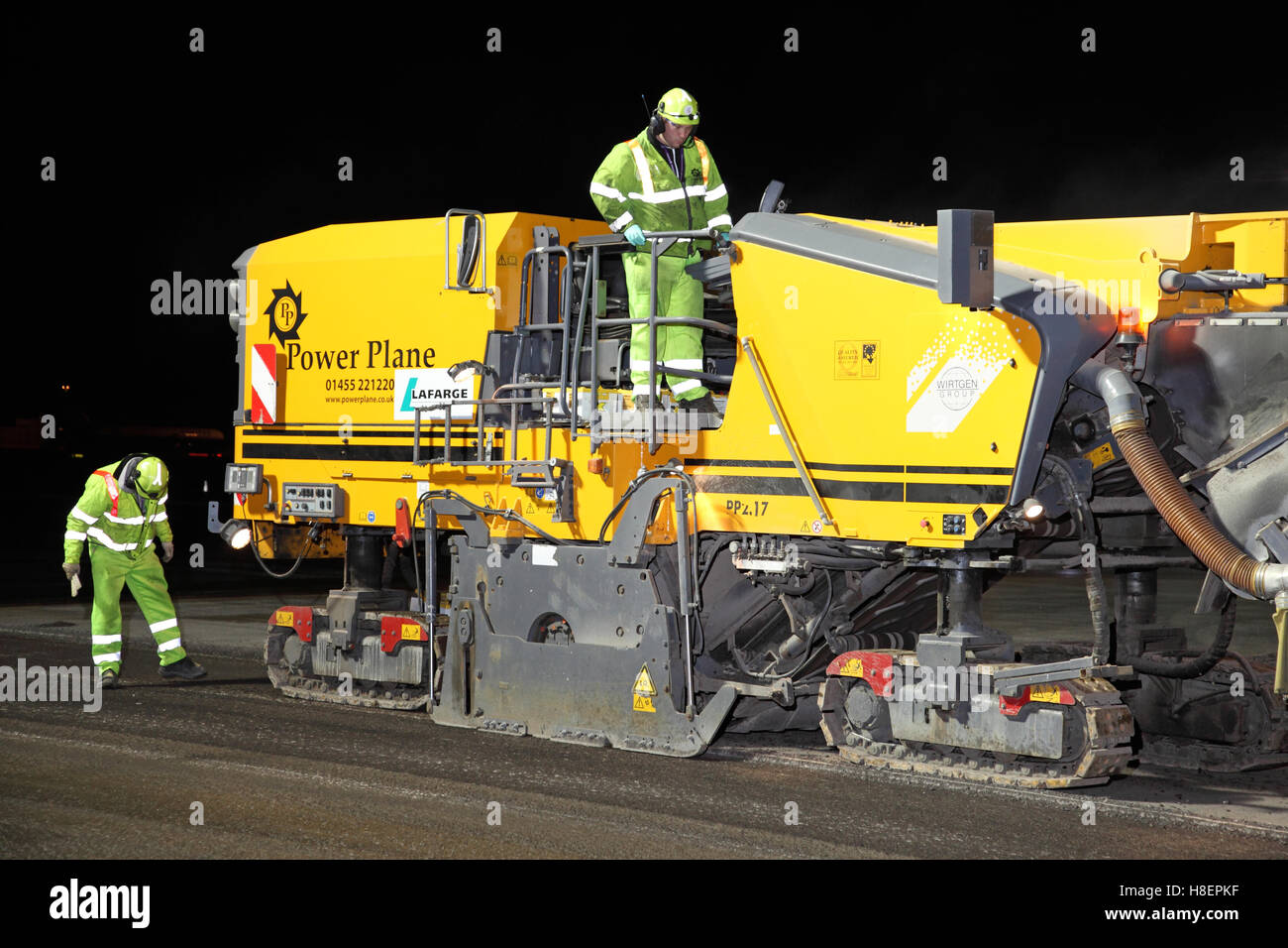 A mechanical road plane removes the asphalt surface of a motorway ...