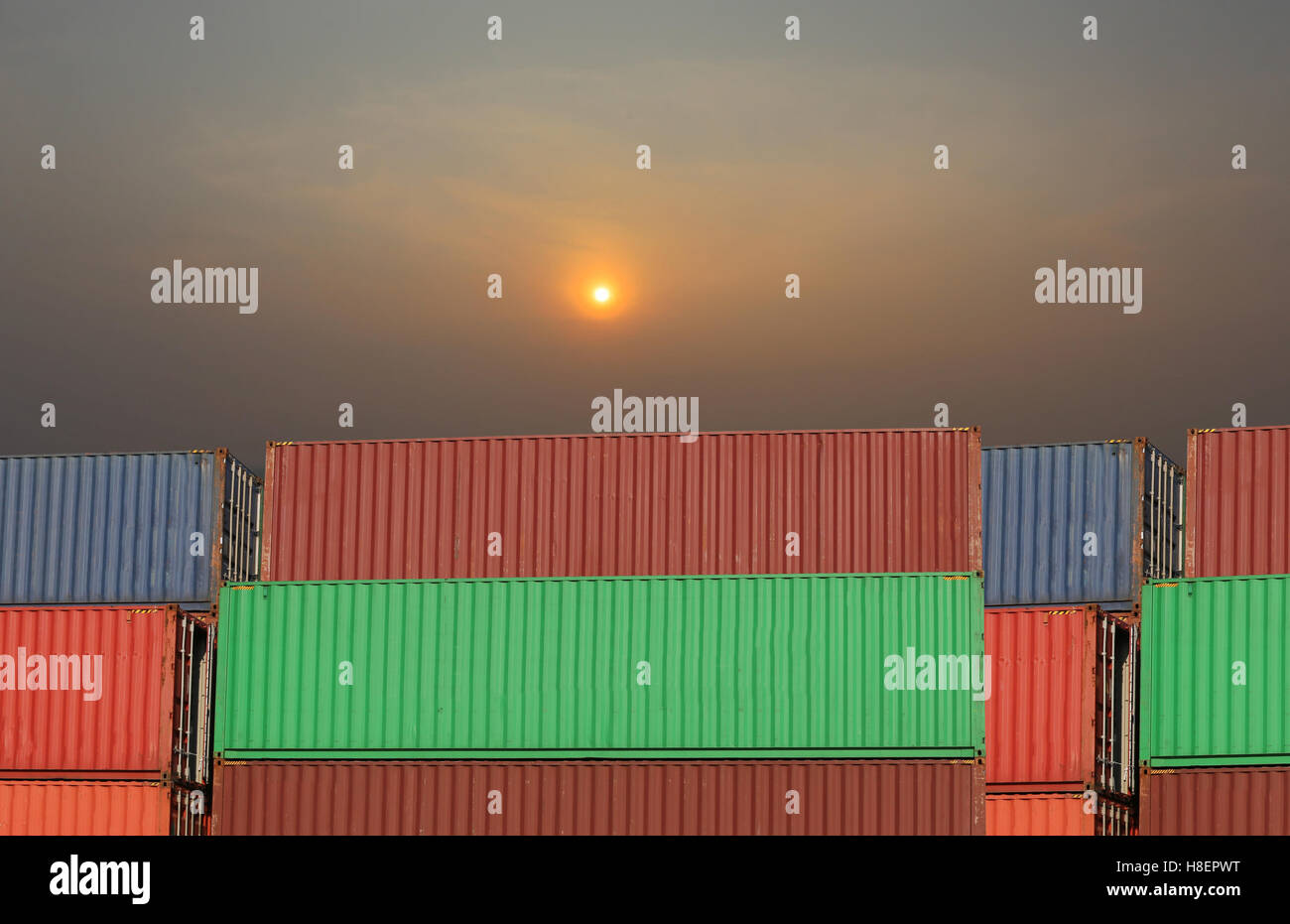 Cargo containers stack in sea port and sunset background Stock Photo ...