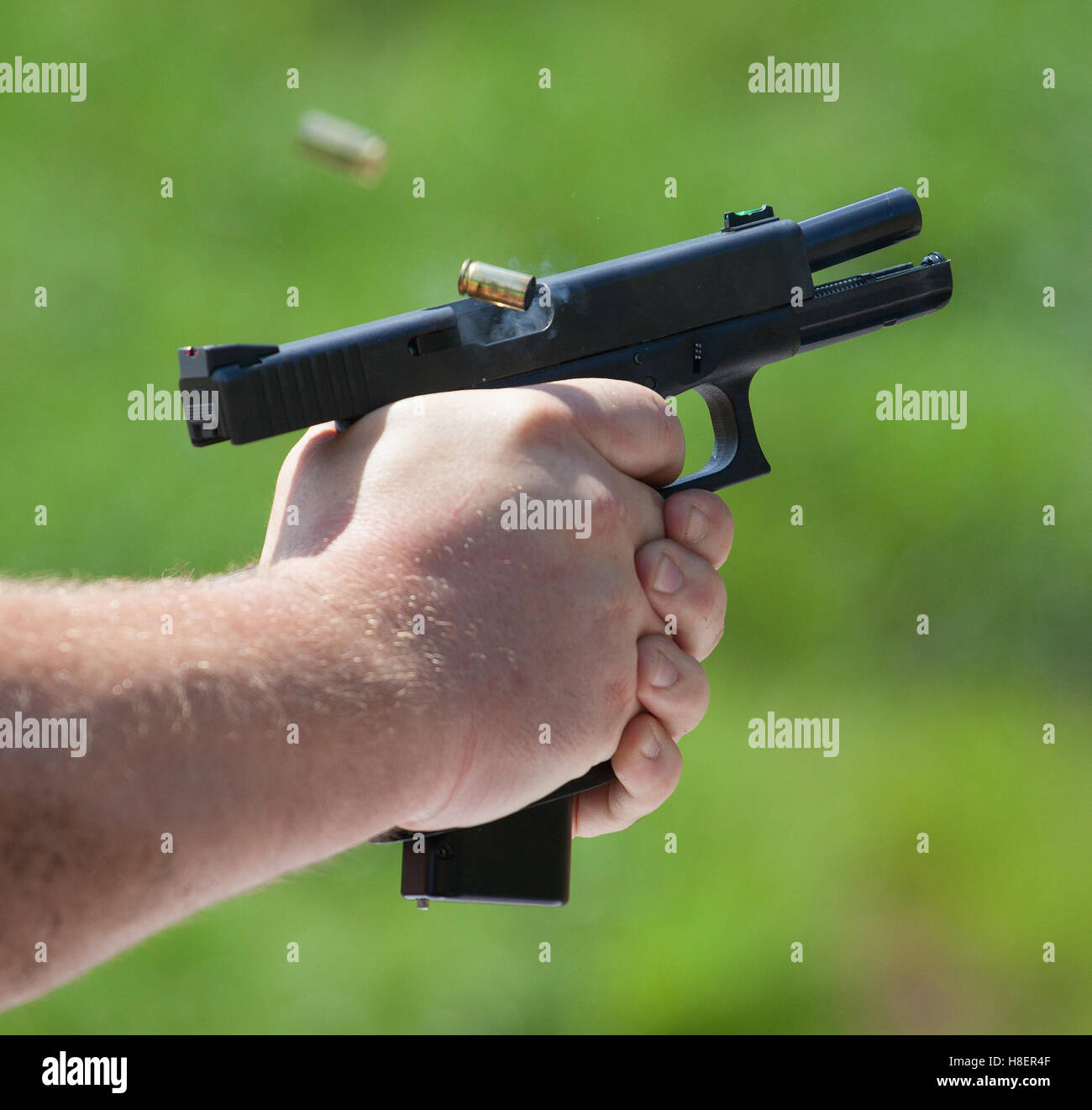 Polymer handgun that has delivered two fast shots Stock Photo - Alamy