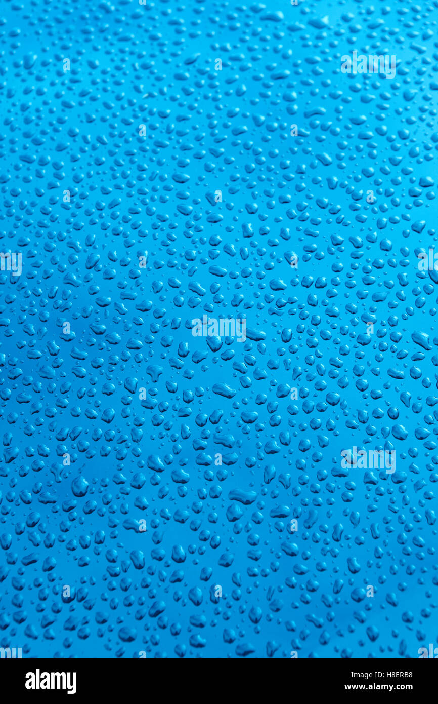 Drops of water background in blue tone. Vertical format Stock Photo - Alamy