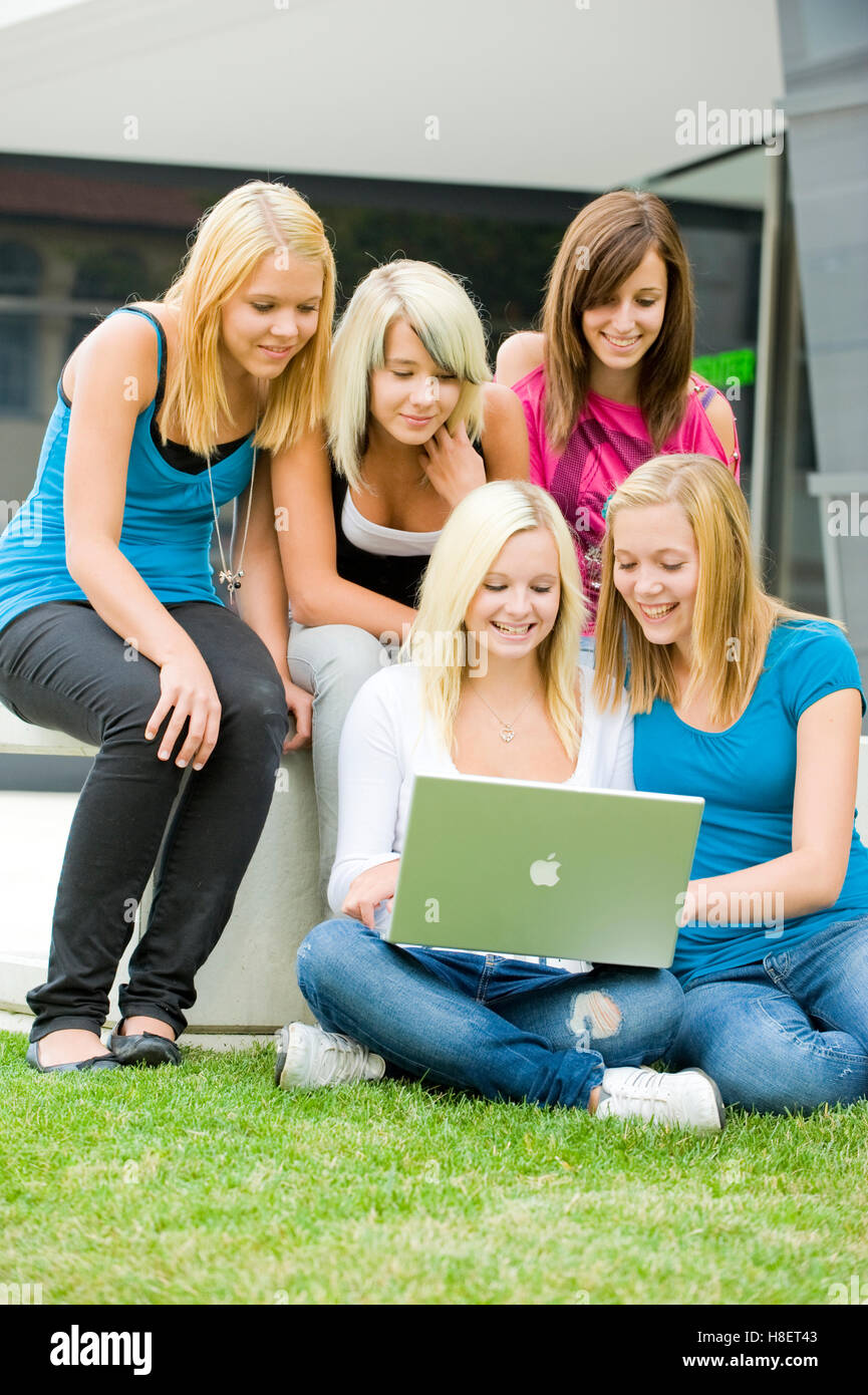 Group of teenage girls using laptop Stock Photo - Alamy