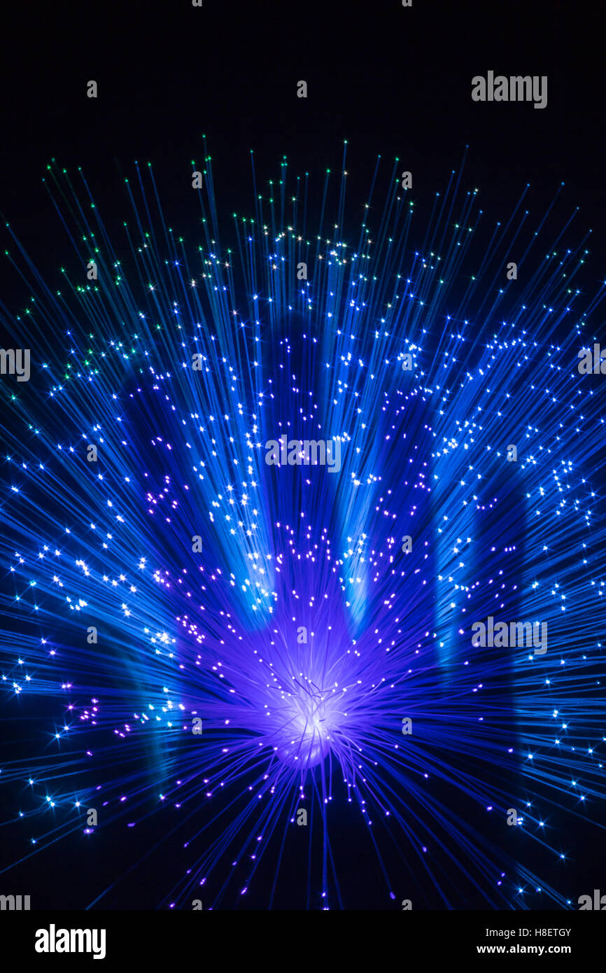 SILHOUETTE OF HUMAN HAND OVER LIT TIPS OF FIBER OPTIC STRANDS (©KECK ...