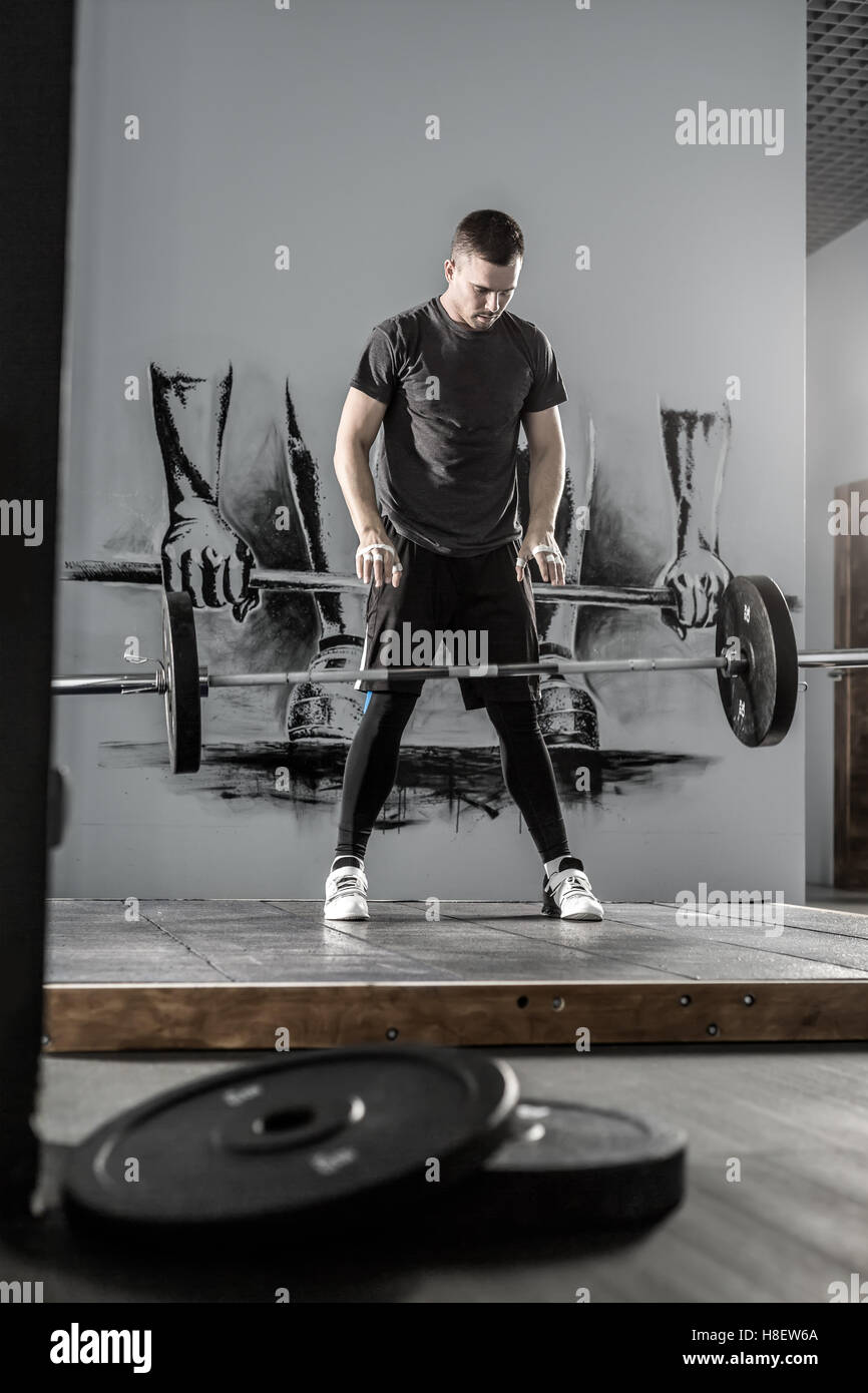 Workout with barbell in gym Stock Photo - Alamy