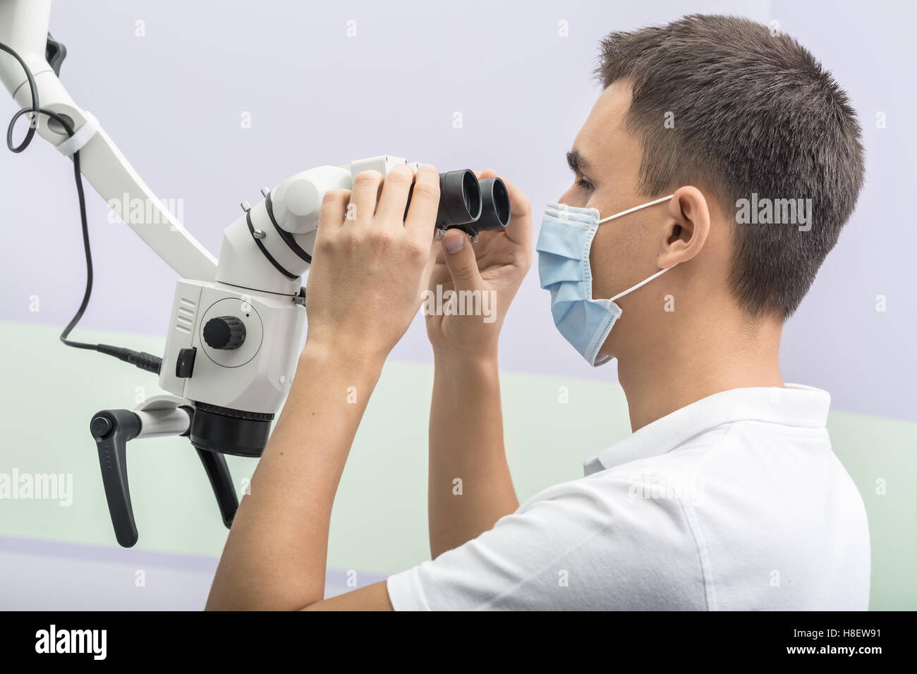 Dentist using a dental microscope Stock Photo - Alamy