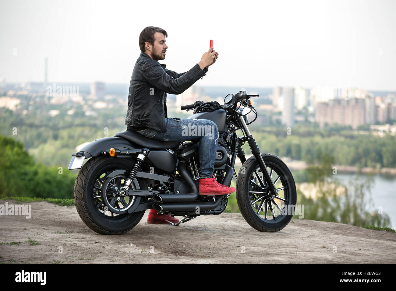 Motorcyclist on the city background Stock Photo - Alamy