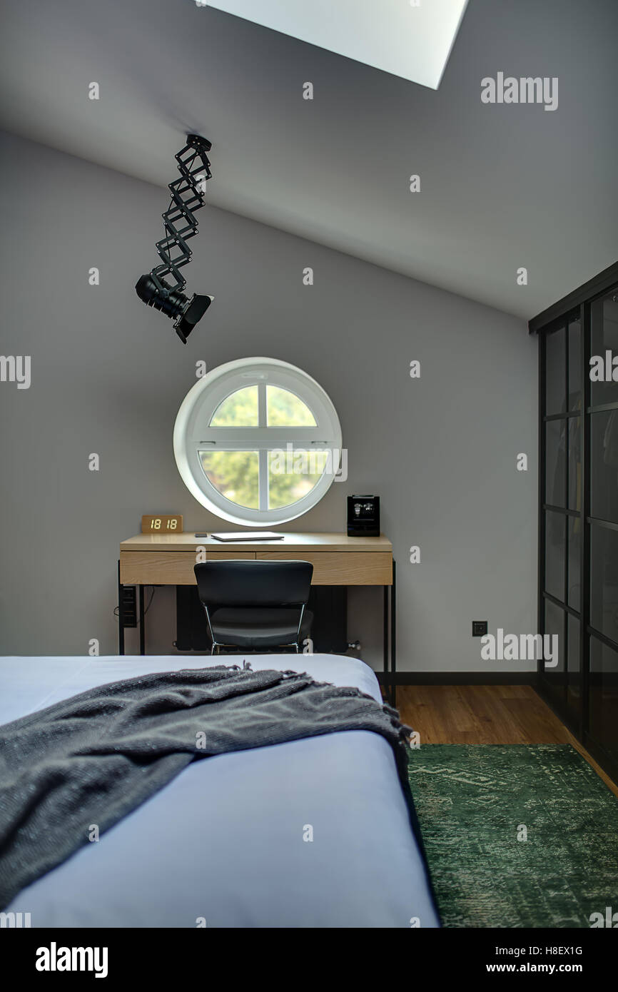 Bedroom with round window Stock Photo - Alamy