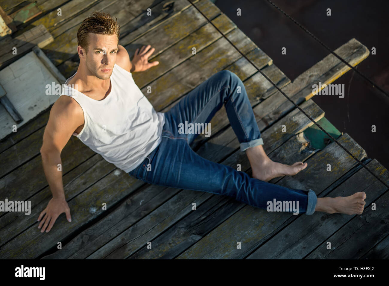 Barefoot man jeans hi-res stock photography and images - Alamy