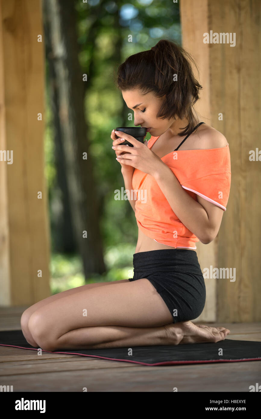 Yoga girl with cup Stock Photo - Alamy