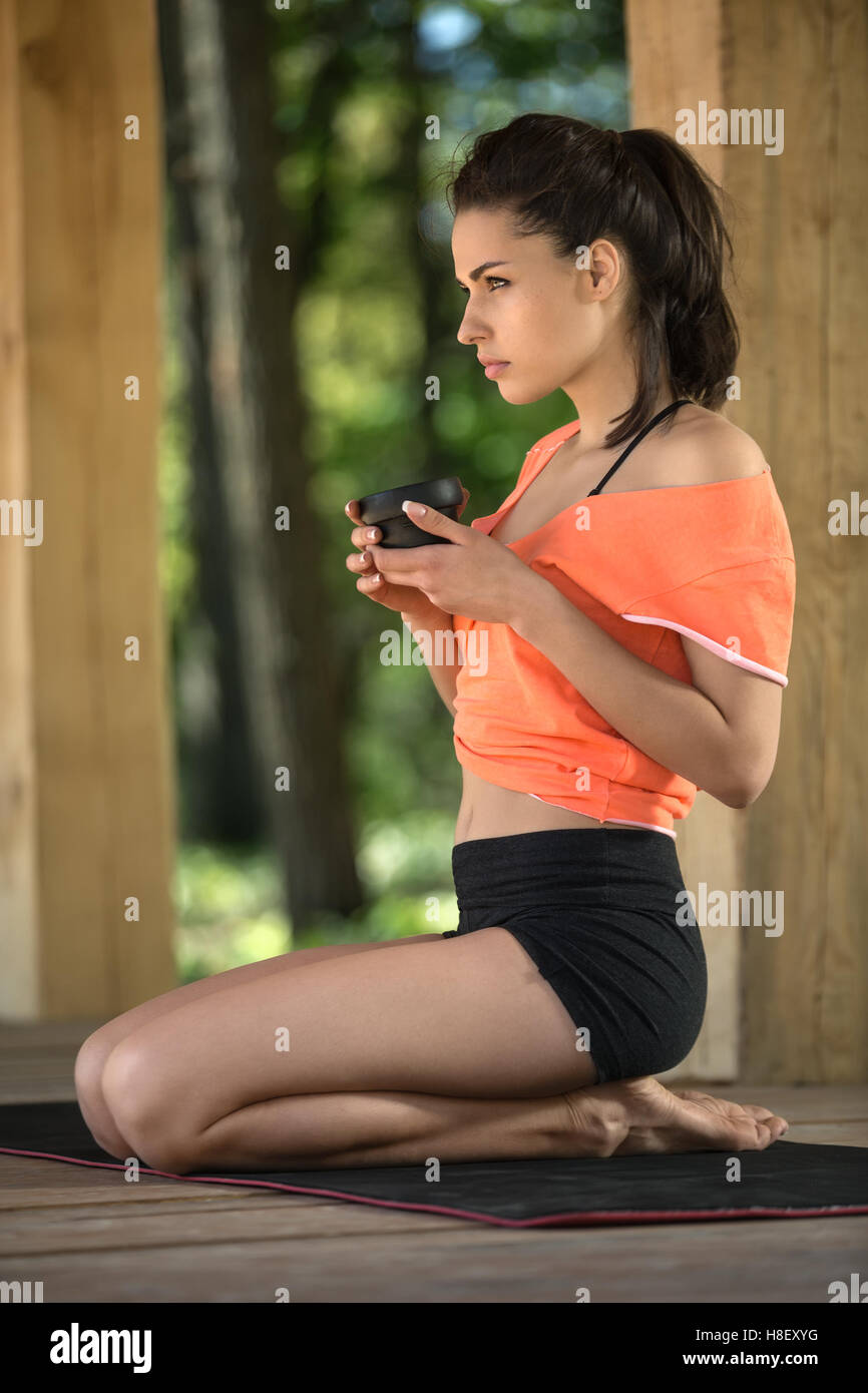 Yoga girl with cup Stock Photo - Alamy
