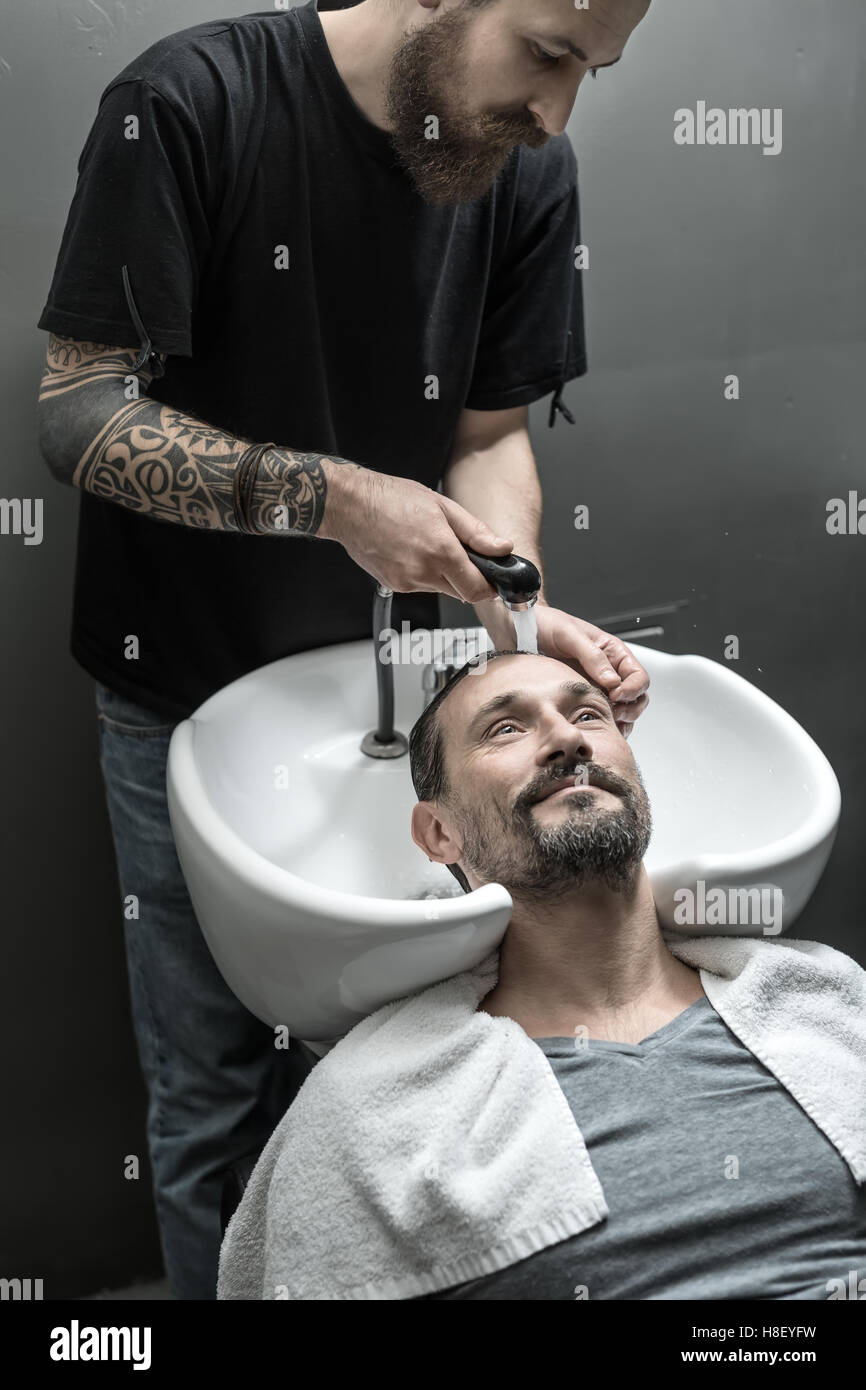 Washing head in barbershop Stock Photo - Alamy