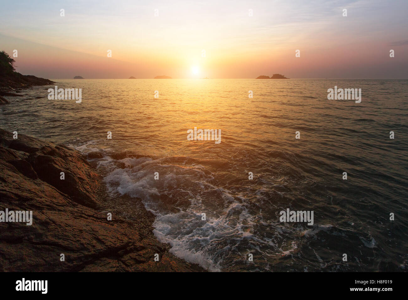 Sunset at rocky sea coast Stock Photo - Alamy