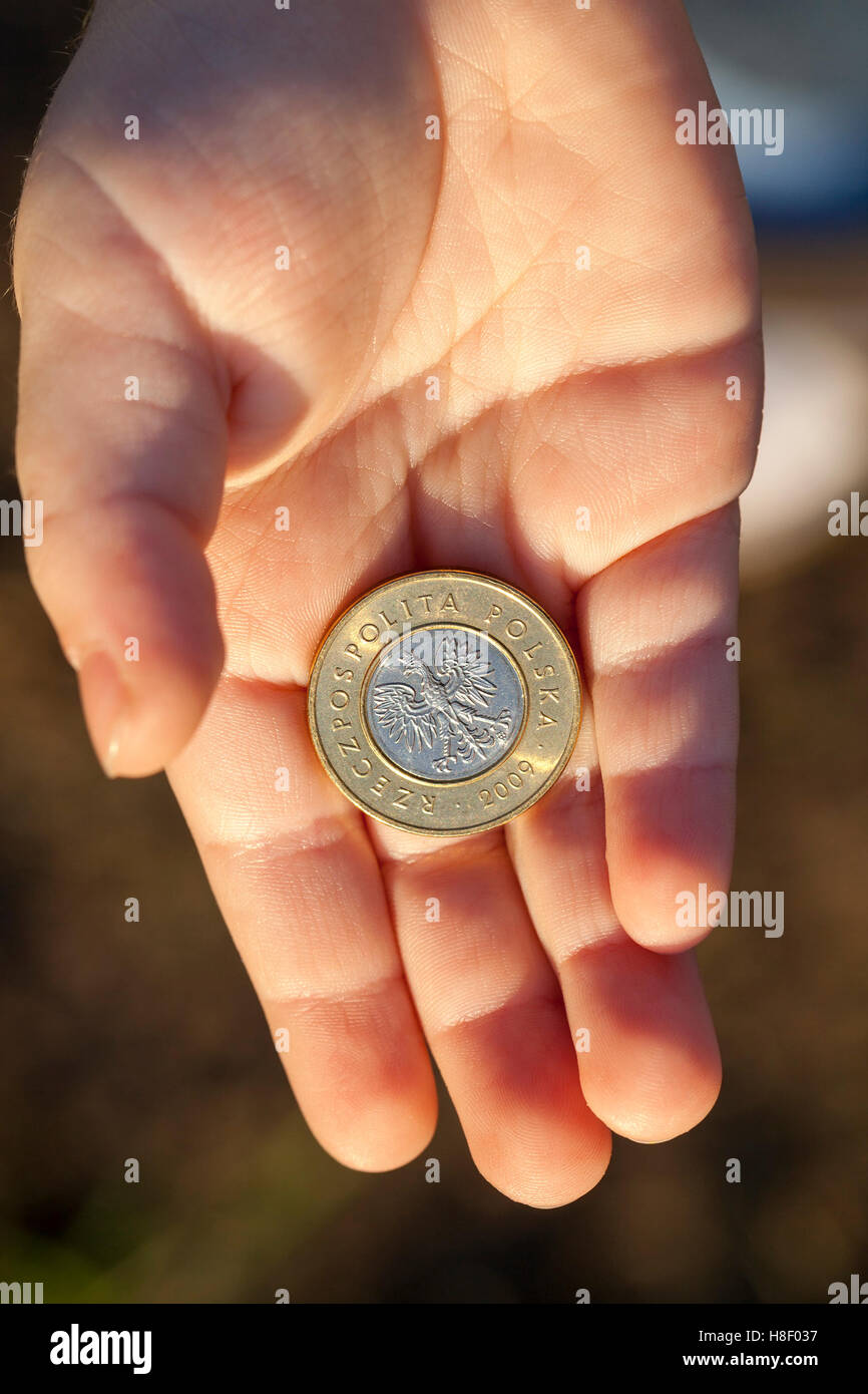 Child holding a coin hi-res stock photography and images - Alamy