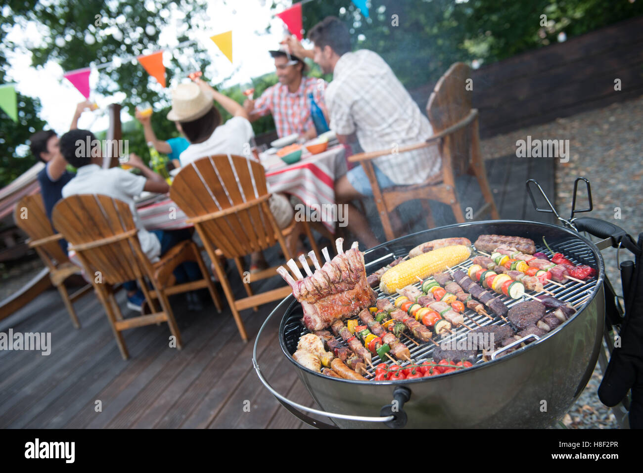 Family having a barbecue party in their garden in summer Stock Photo ...