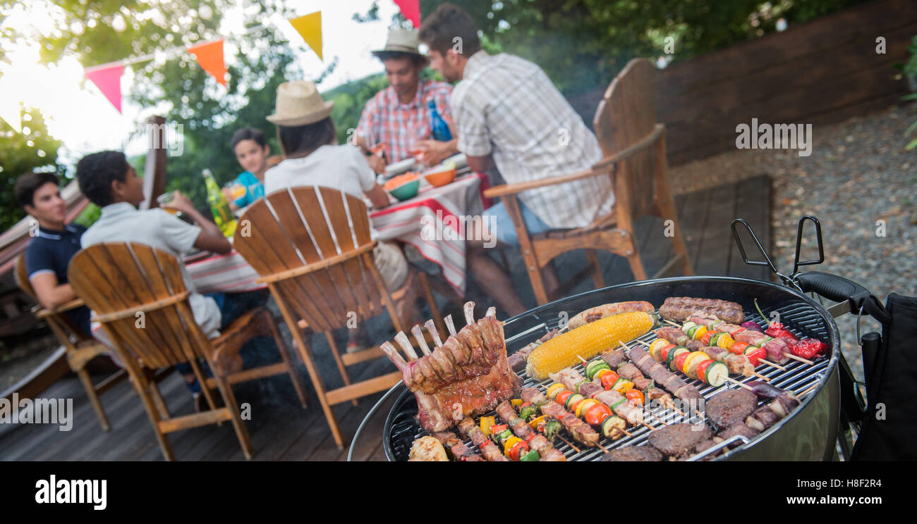 Family having a barbecue party in their garden in summer Stock Photo ...