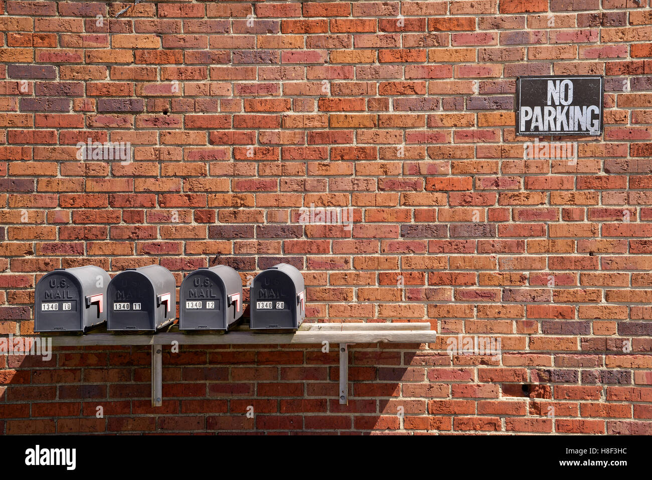 U.S. Mail Boxes against a brick wall with no parking sign Stock Photo ...