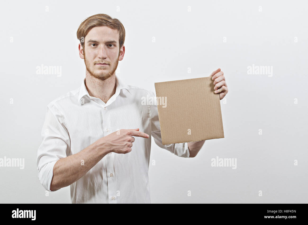 Young Adult Man in White Shirt Holding a Big Cardboard Inscription ...