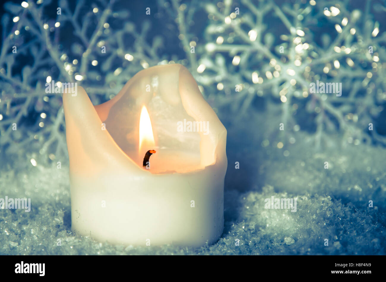 white burning candle and shining snowflakes Stock Photo - Alamy