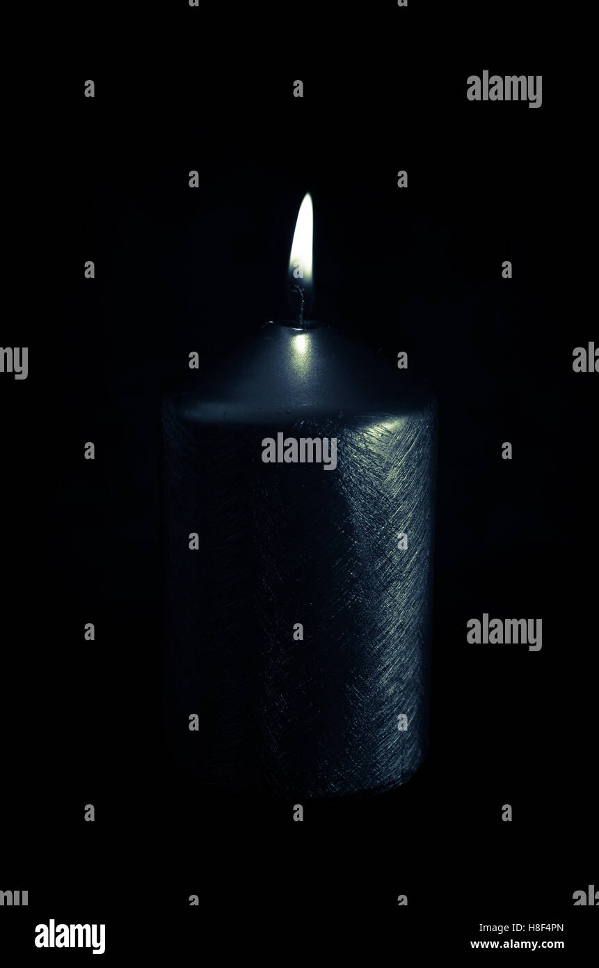 silver burning candle with black background Stock Photo - Alamy