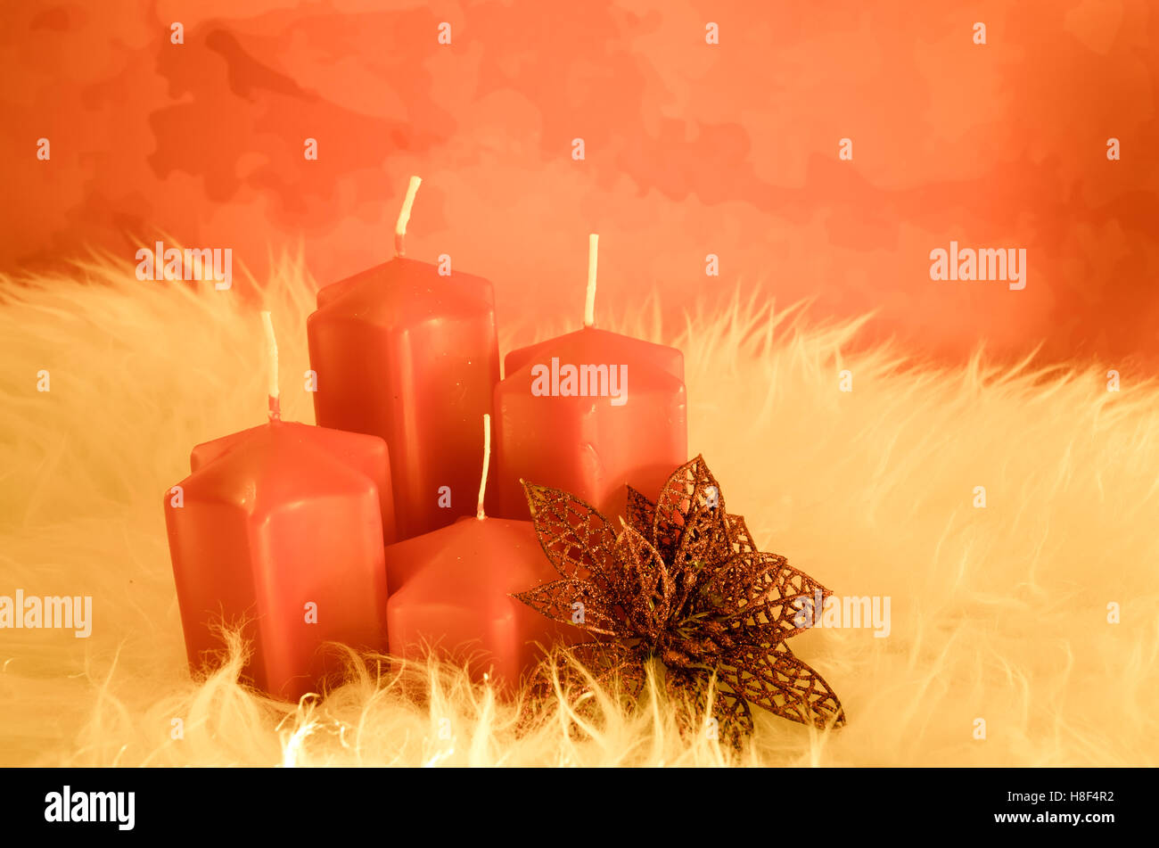 four unlit red advent candles with orange background Stock Photo - Alamy