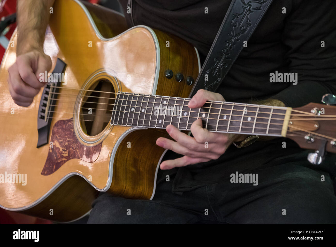 Man plays acoustic guitar Stock Photo - Alamy