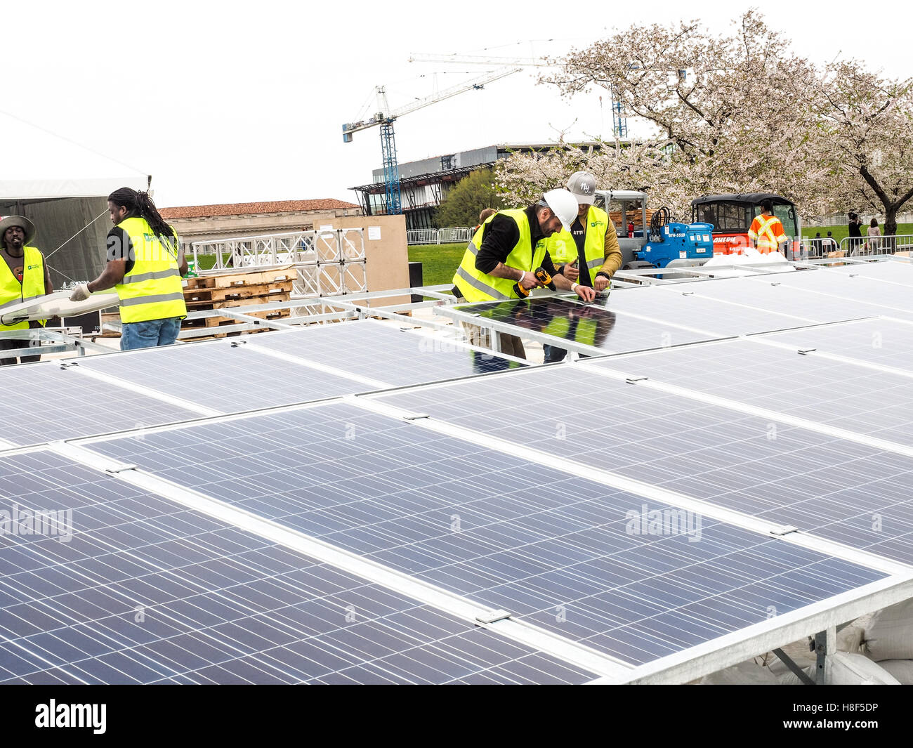 Workers install Solar Panels on Washington Mall with Washington ...