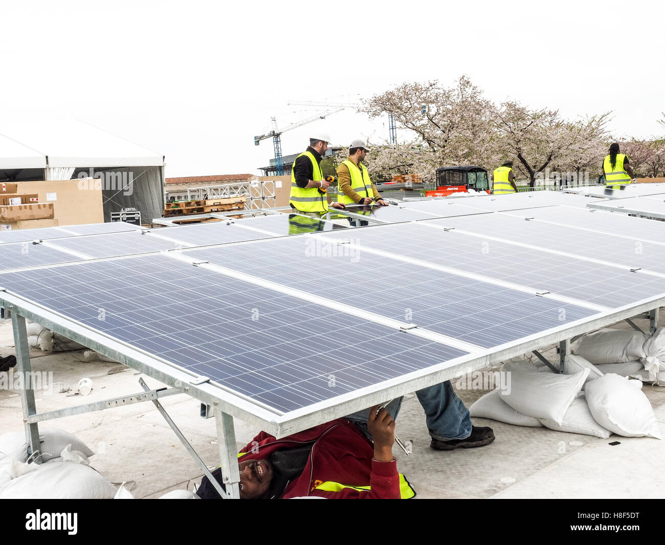 Workers install Solar Panels on Washington Mall with Washington ...