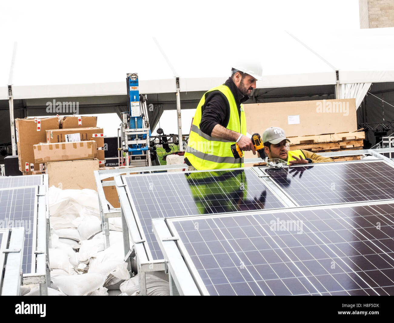 Workers install Solar Panels on Washington Mall with Washington ...