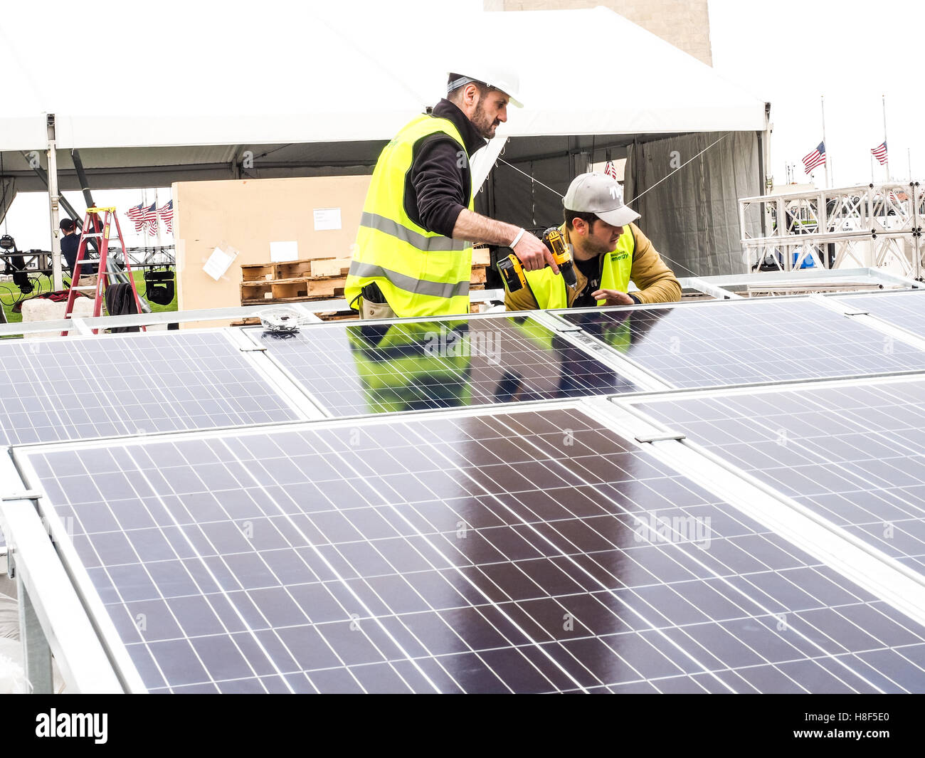 Workers install Solar Panels on Washington Mall with Washington ...