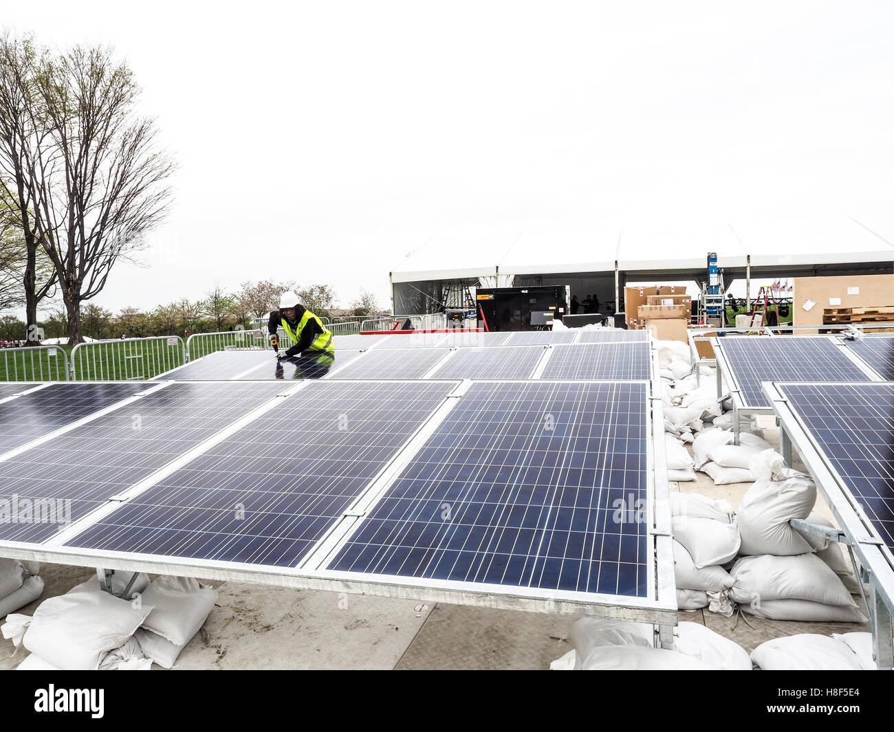 Workers install Solar Panels on Washington Mall with Washington ...