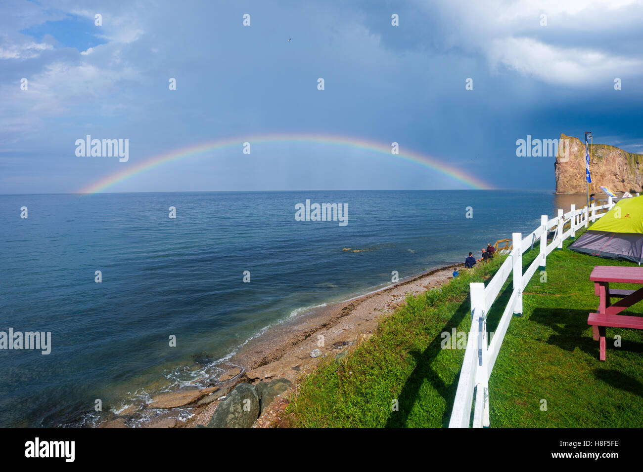 Rainbow over water Stock Photo - Alamy