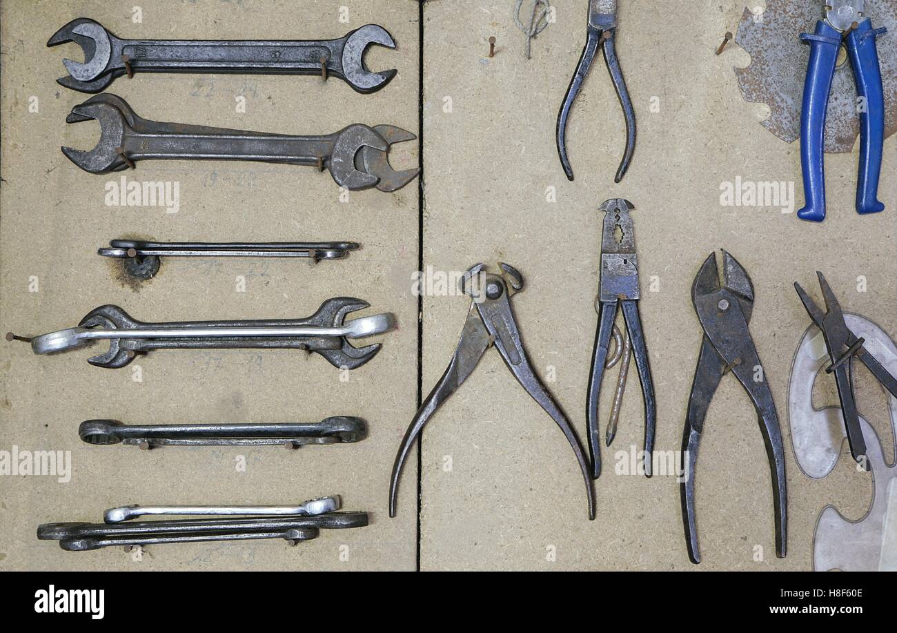Various vintage old metal tools on wooden board in workshop Stock Photo ...