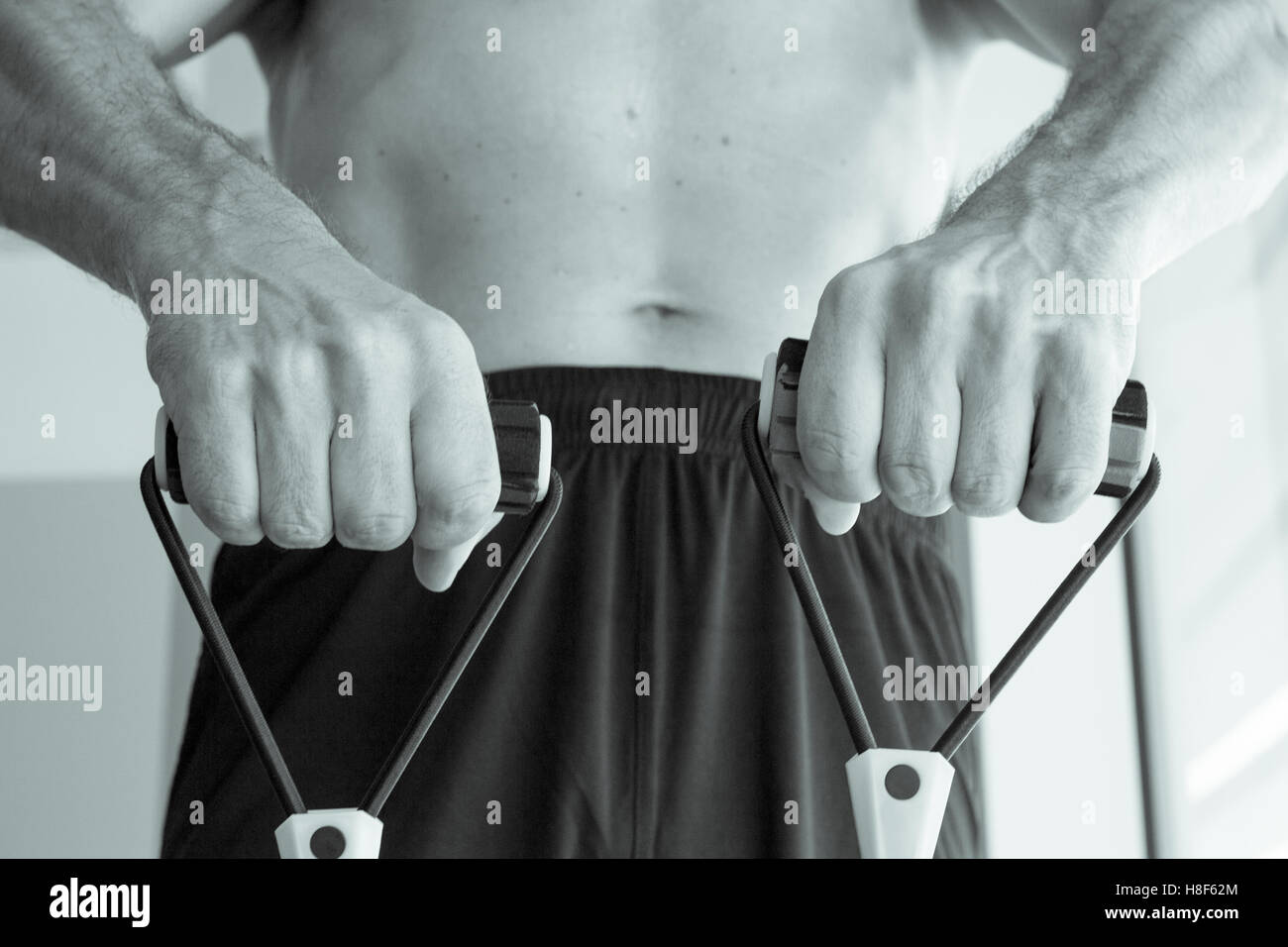 Performing exercises with resistance rope fitness Stock Photo - Alamy