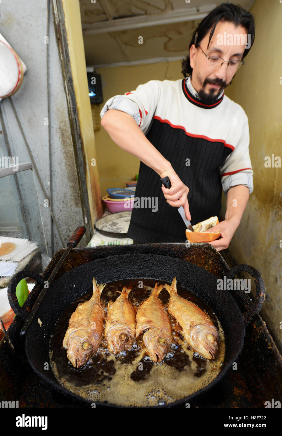 Moroccan fried fish fried in a small street food stall in the Medina of ...