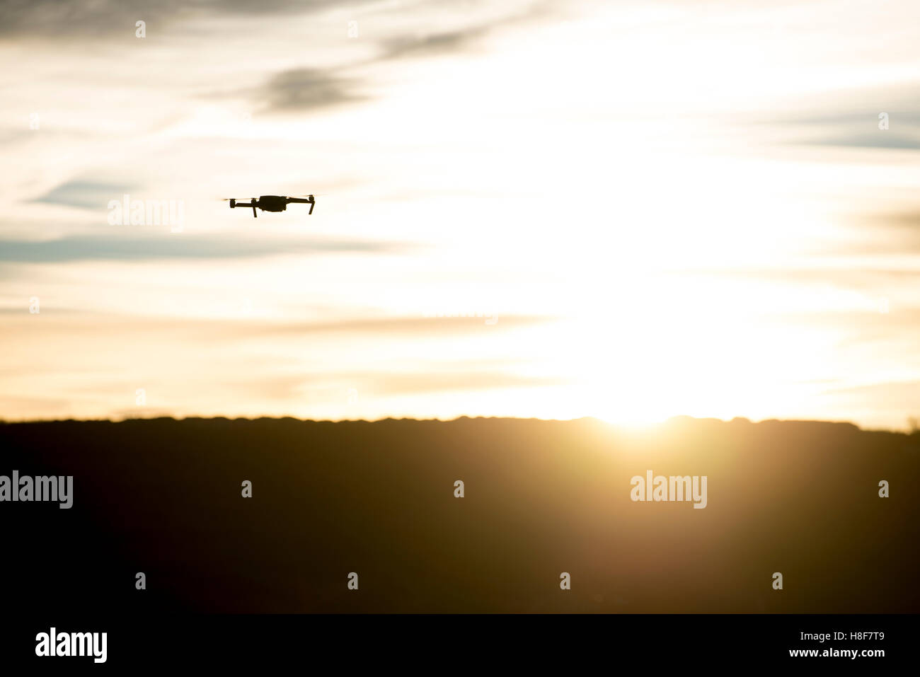 Modern drone silhouetted against sunset Stock Photo - Alamy