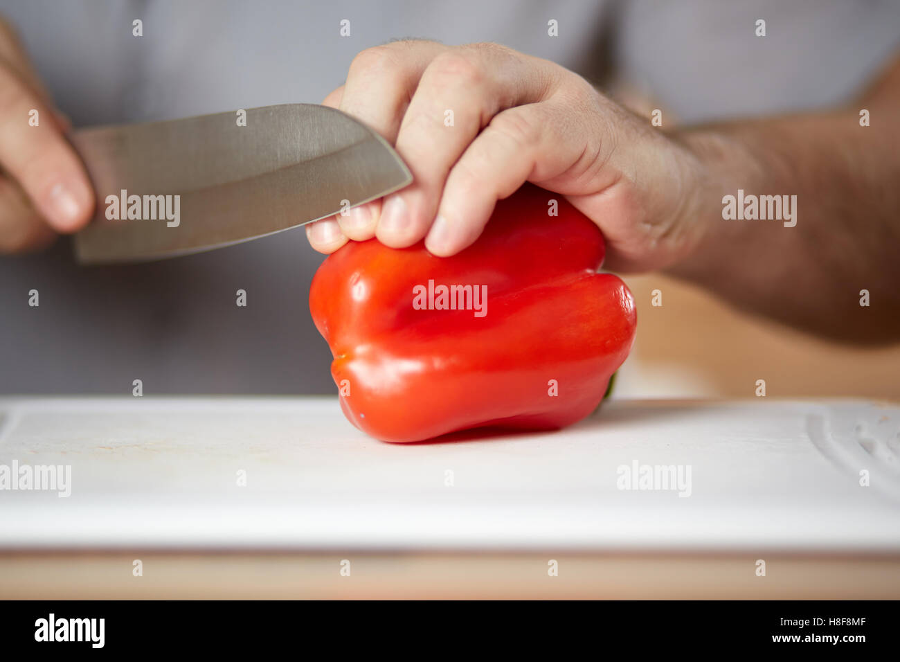 Person cutting up red peppers hi-res stock photography and images - Alamy